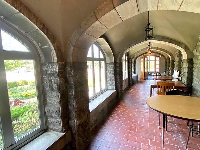 Sunlight streams through arched windows in this garden corridor, where stone meets nature in a perfect architectural handshake.