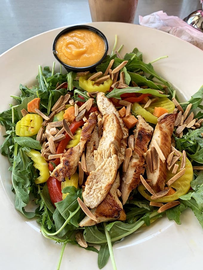 A salad that doesn't feel like punishment. Grilled chicken, fresh greens, and that sunset-colored dressing create the rare healthy option you'll actually crave again.