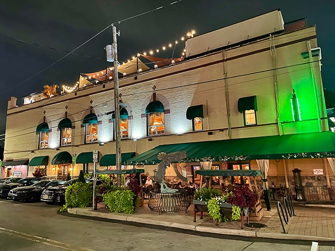 The Great American Pub glows with invitation after dark, its string lights promising cold drinks and warm conversations inside.