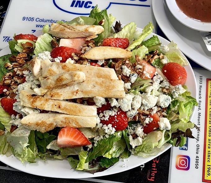 Even salads get the royal treatment here—strawberries, grilled chicken, and blue cheese proving healthy doesn't mean boring.