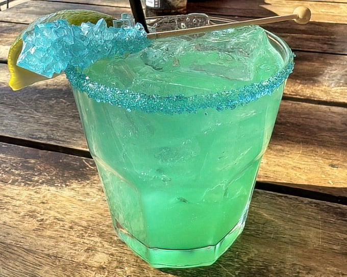 This electric blue concoction isn't just a drink – it's vacation in a glass, complete with sugar rim and enough ice to sink a tiny paper umbrella.