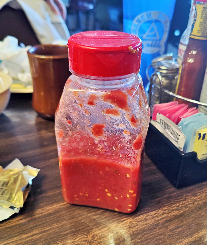 Homemade salsa that's seen things – a bottle of liquid personality that's not afraid to bring the heat to your breakfast party.