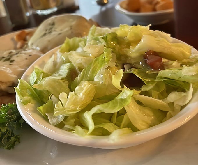 A simple salad elevated to art form with what appears to be the legendary hot bacon dressing—proof that Pennsylvania Dutch cooks knew vegetables needed persuasion to shine.