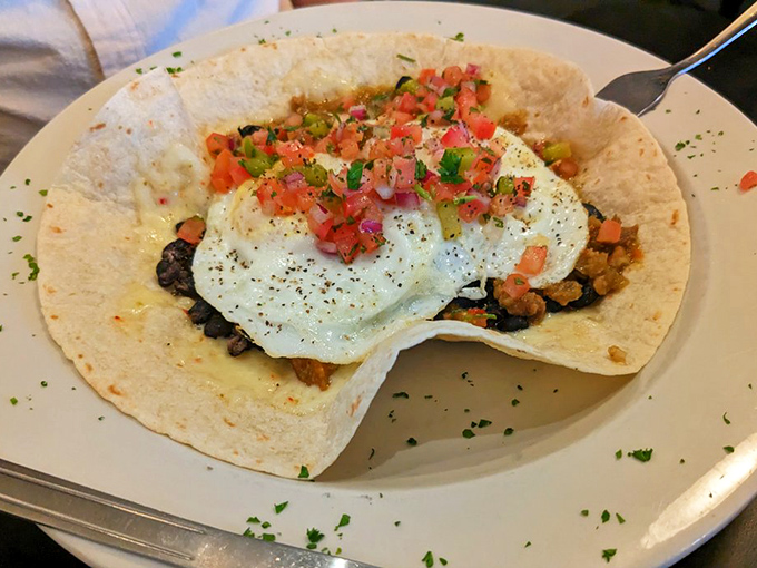 These Huevos Rancheros don't just cross borders—they erase them. Fresh pico de gallo adds a splash of color that wakes up your taste buds.