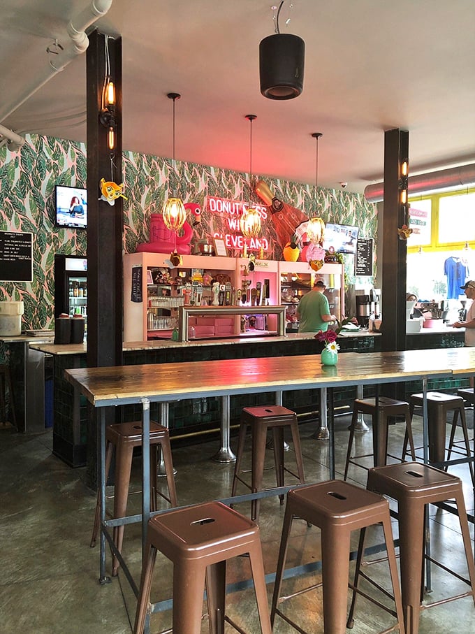 Pink cabinets, tropical wallpaper, and a neon sign declaring "DONUT MESS WITH CLEVELAND"—this counter area is what Instagram dreams are made of.