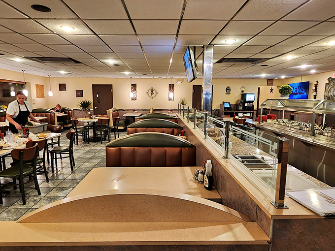 The dining room view reveals the buffet line—a gastronomic runway where comfort food struts its stuff without an ounce of pretension.
