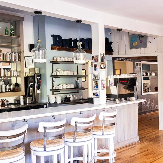 The counter seating area combines farmhouse charm with coffee bar efficiency—the breakfast equivalent of business in front, party in back.
