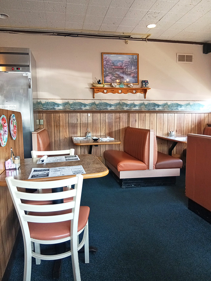 Wood paneling, landscape art, and booths designed for lingering conversations—this corner of the dining room has witnessed countless family stories.