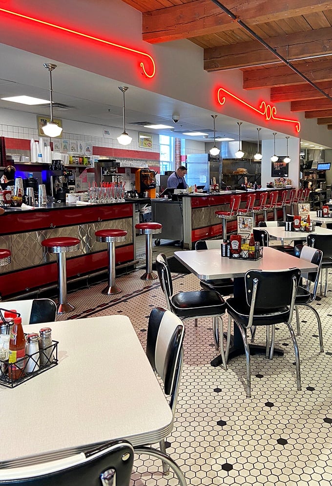 The counter beckons like an altar to American dining—red stools awaiting pilgrims seeking salvation in the form of milkshakes and burgers.