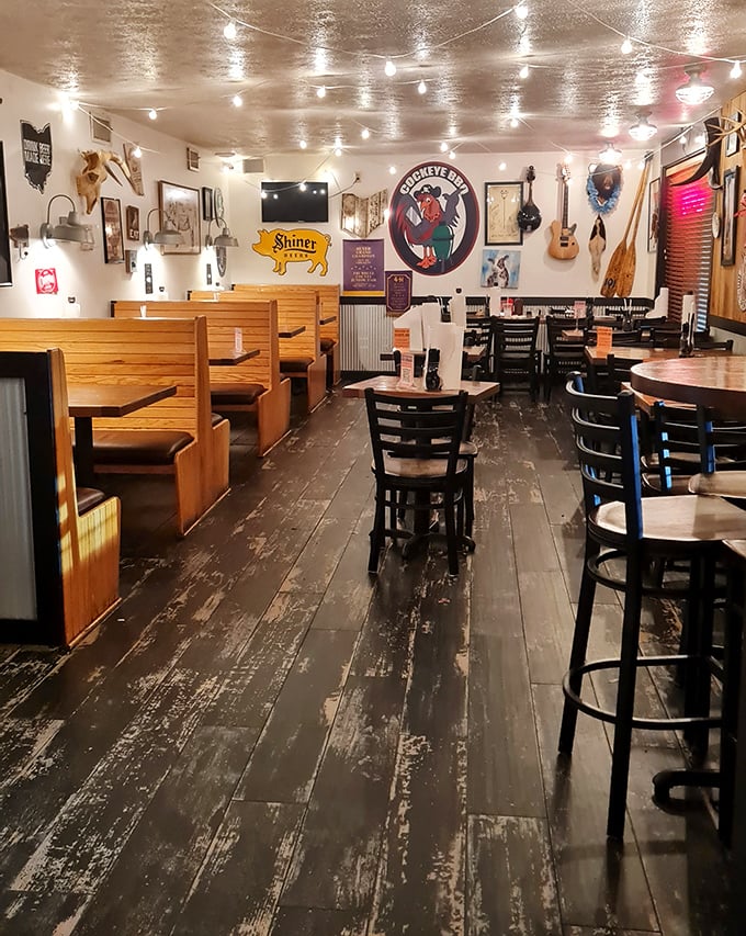 String lights, wooden booths, and BBQ memorabilia—the holy trinity of authentic barbecue ambiance. That worn floor has stories to tell.