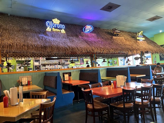 The thatched tiki bar brings beach vibes indoors, proving paradise isn't a place—it's wherever you're eating a perfect burger.