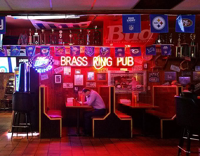 The neon glow creates that perfect dive bar ambiance where great food and conversation flow as freely as the beer.