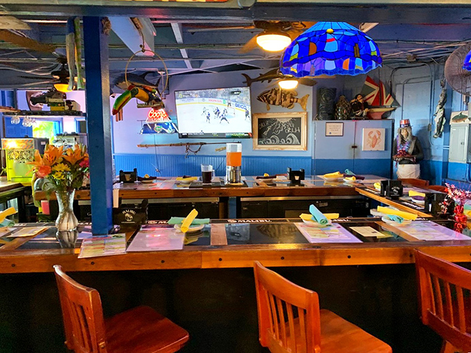 Blue walls and wooden tables create the perfect backdrop for seafood feasting. The nautical décor reminds you that fresh catches are just outside.