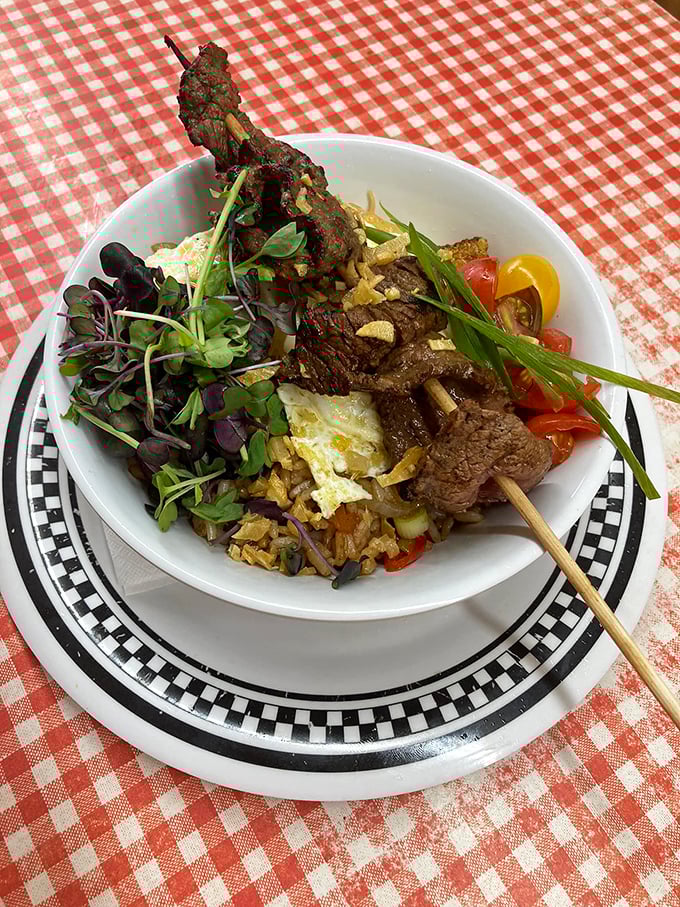 A feast that defies categorization—tender beef skewers, vibrant vegetables, and perfectly cooked rice create a surprising symphony of flavors in this diner classic. 