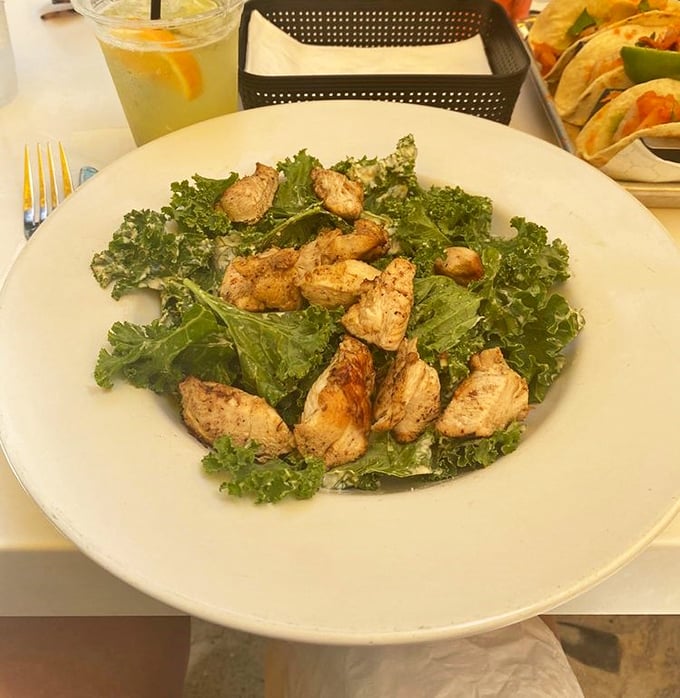 The Kale Caesar proves that healthy eating doesn't mean punishment—tender greens and perfectly seasoned chicken create a salad worth crossing state lines for.