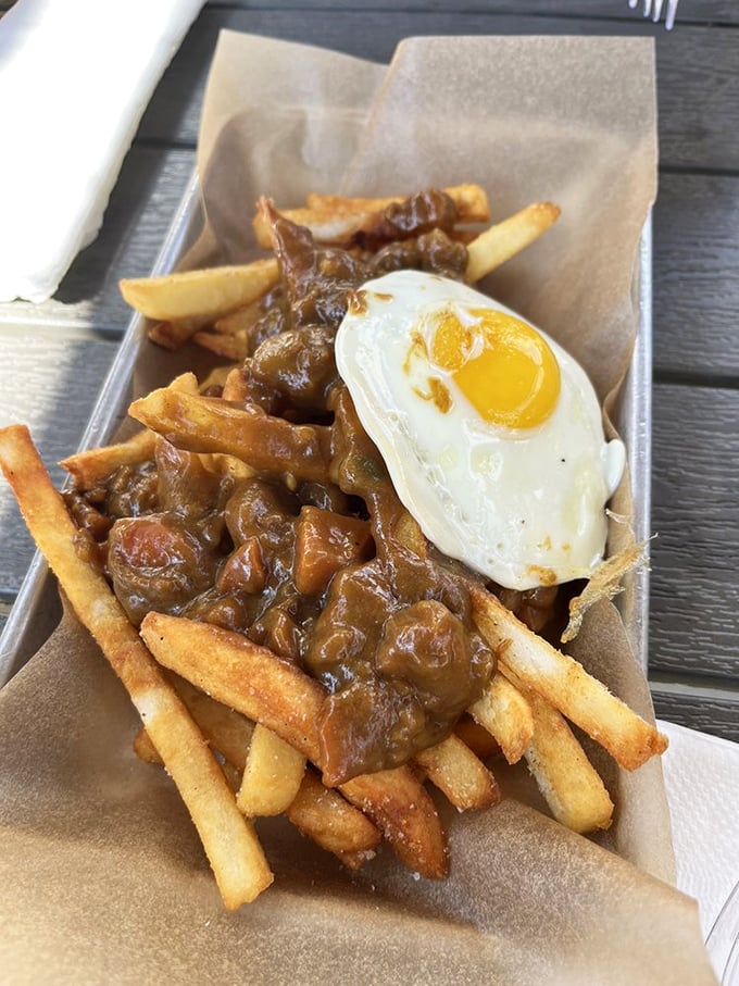 Fries swimming in curry gravy with a sunny-side-up egg – like breakfast and dinner had a delicious love child.