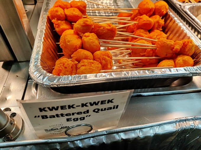 Kwek-kwek – quail eggs wearing bright orange batter coats that make them look like they're dressed for a tropical vacation.