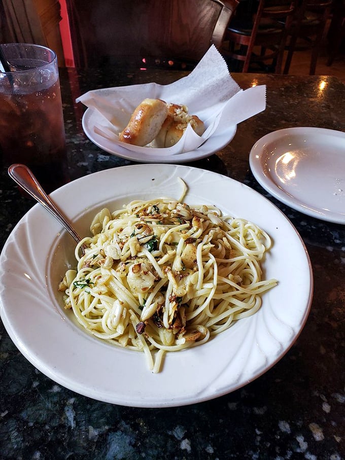 Linguine preparation showcasing the kitchen's understanding that proper sauce-to-pasta ratios can make or break dinner dreams.