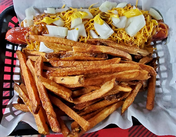 These aren't just loaded fries—they're an engineering marvel. A foundation of crispy potatoes supporting a skyscraper of toppings.
