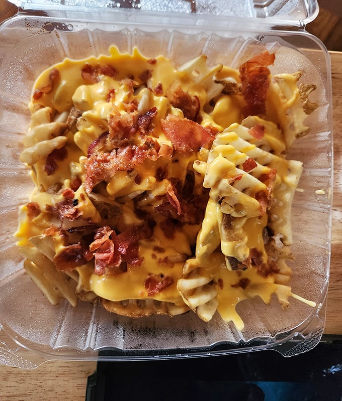 Waffle fries transformed into a cheese-and-bacon playground—where every forkful is a treasure hunt for the perfect combination of crispy, gooey, and smoky.