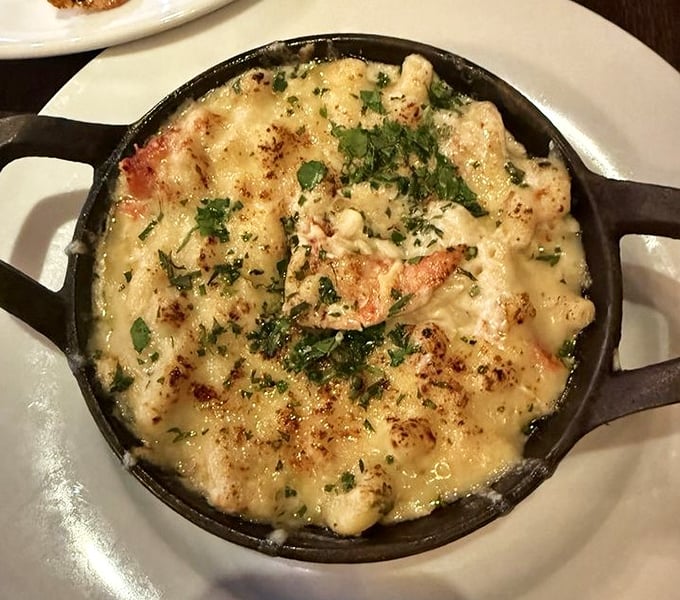 Lobster mac and cheese that's been promoted to the executive suite—rich, decadent, and served in a cast iron skillet that keeps it bubbling until the last bite.