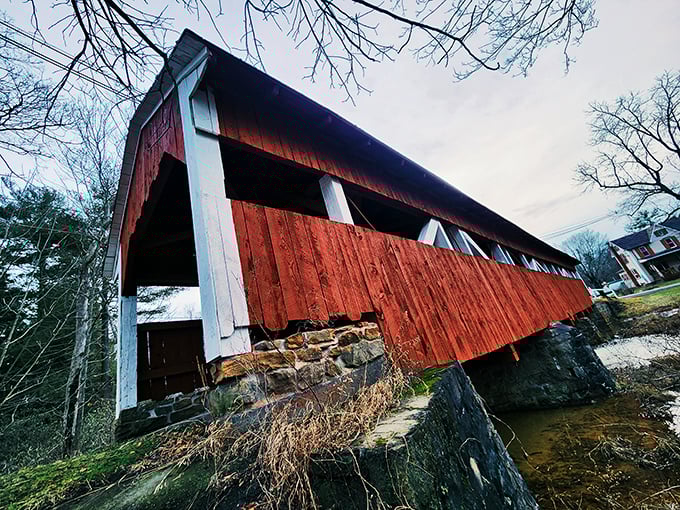 The dramatic angle reveals the bridge's impressive stone foundations—engineering marvels that have withstood countless spring floods and winter freezes.