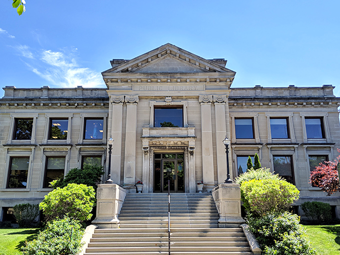 The Manistee County Library doesn't just house books; it's a temple to knowledge wrapped in limestone dignity and crowned with classical details.