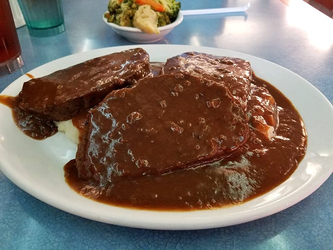 Old-fashioned meatloaf swimming in rich gravy – comfort food that would make your grandmother weep with envy and pride.