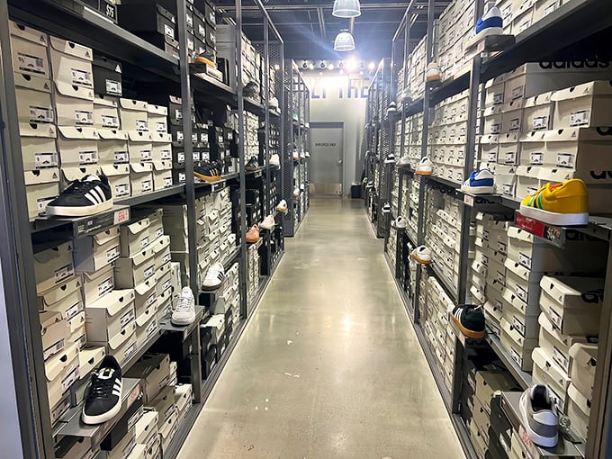 The sneaker vault – where Adidas boxes stack like a temple to athleisure and finding your size feels like winning a small lottery.