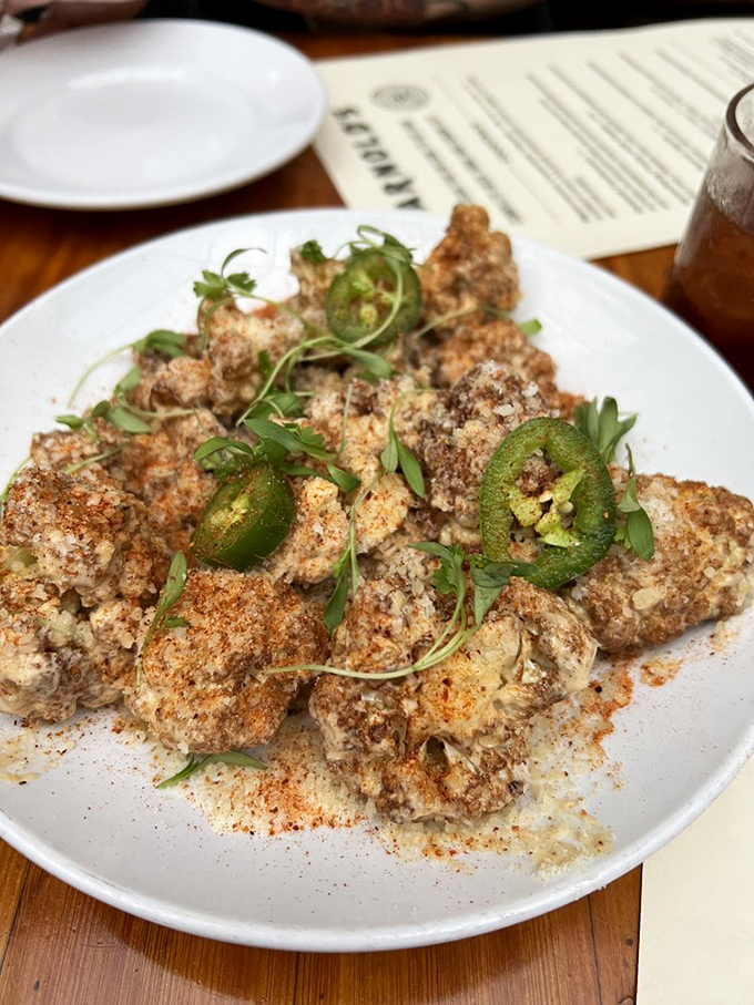 These aren't your average brussels sprouts—they're the cool cousins who studied abroad. Crispy, spiced, and lounging on a bed of creamy hummus.