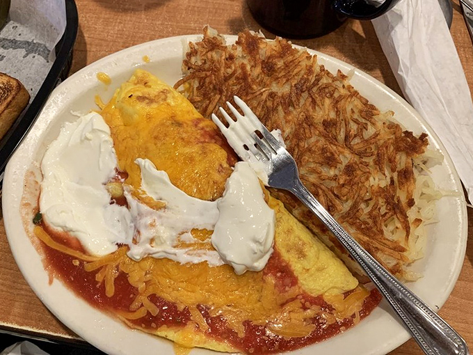 This isn't just an omelet—it's a sunrise wrapped in protein. Those hash browns have achieved the crispy-to-fluffy ratio that scientists are still trying to explain.