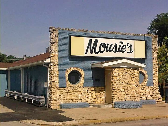 Mousie's blue stone facade promises comfort food that hugs your soul like your favorite sweater from 1982—familiar and perfectly worn-in.