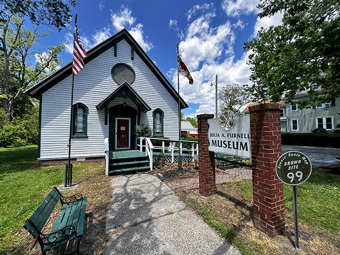 The Julia A. Purnell Museum, housed in this quaint white building, celebrates a woman who began her embroidery career at 85—proof it's never too late.