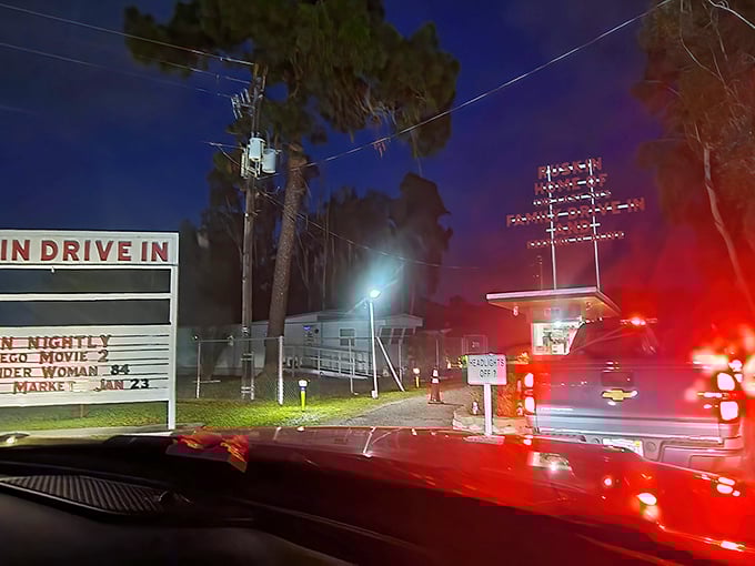 Night arrival at the Ruskin means following taillights to cinematic adventure. The illuminated marquee beckons like a lighthouse for movie lovers.