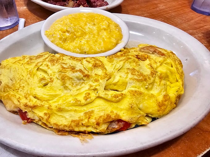 An omelet should be a fluffy envelope delivering good news to your taste buds. This golden creation, paired with grits, is delivering a whole mailbag.
