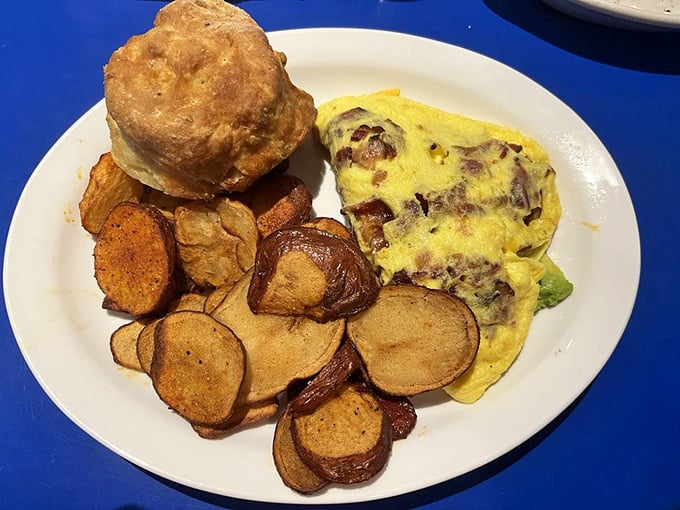 An omelet that knows its purpose in life—to deliver perfect folds of egg around savory fillings alongside home fries that mean business.