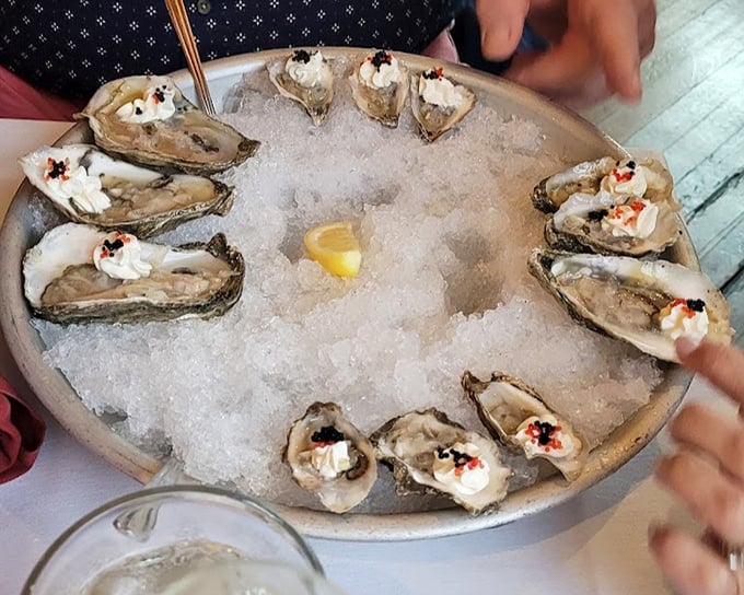 Raw oysters presented on ice like jewels on velvet—briny treasures topped with just enough garnish to enhance, never mask.