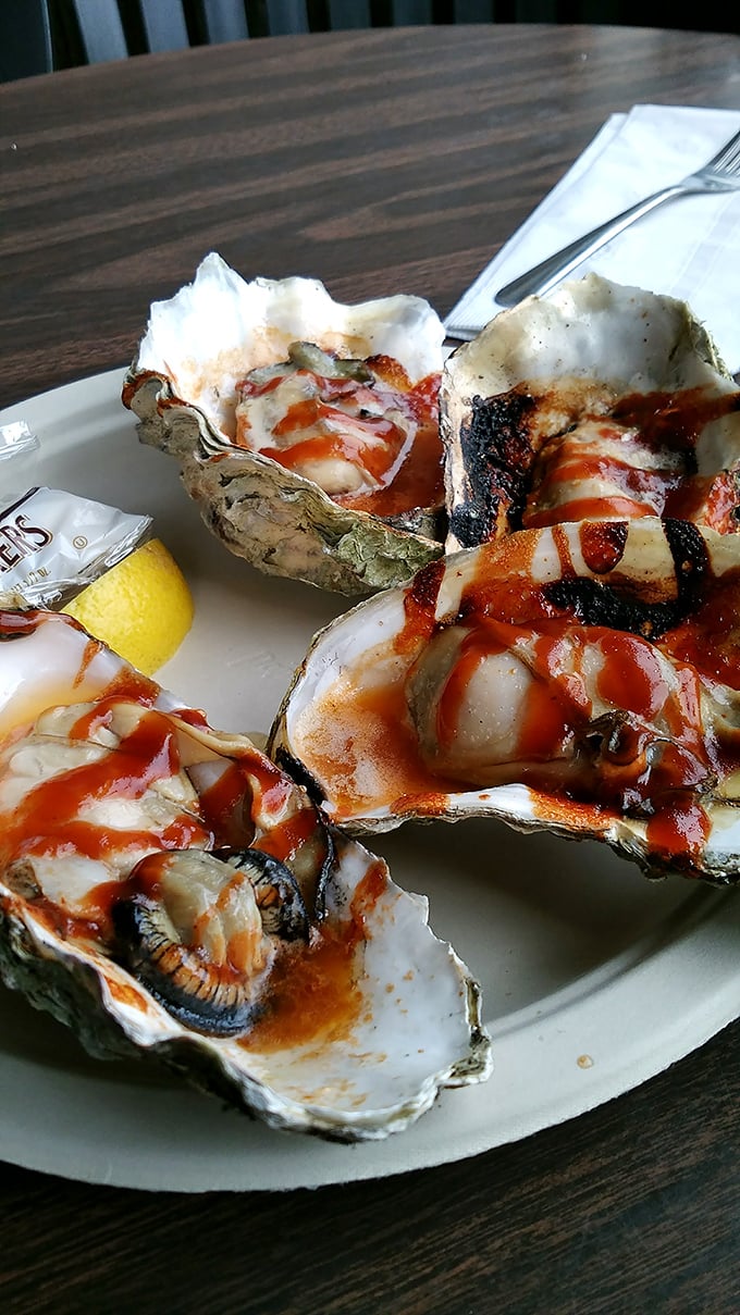 BBQ oysters glistening with sauce—ocean jewels transformed by fire and smoke into something that makes you forget your table manners.