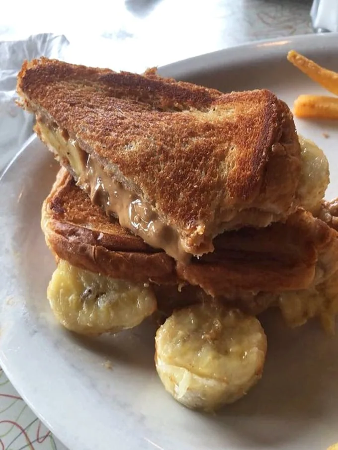This isn't just a sandwich, it's architecture – perfectly toasted bread supporting the sweet-savory symphony of peanut butter and banana that once wooed The King himself.