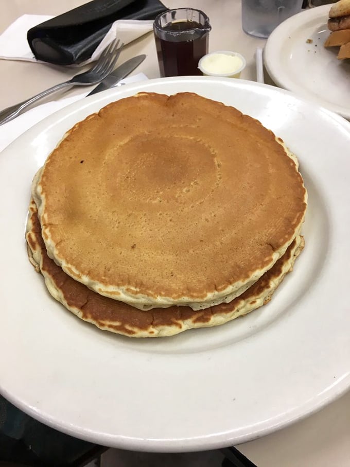 Pancakes so perfectly golden they look like they were tanned on a California beach – fluffy enough to use as a pillow in breakfast heaven.