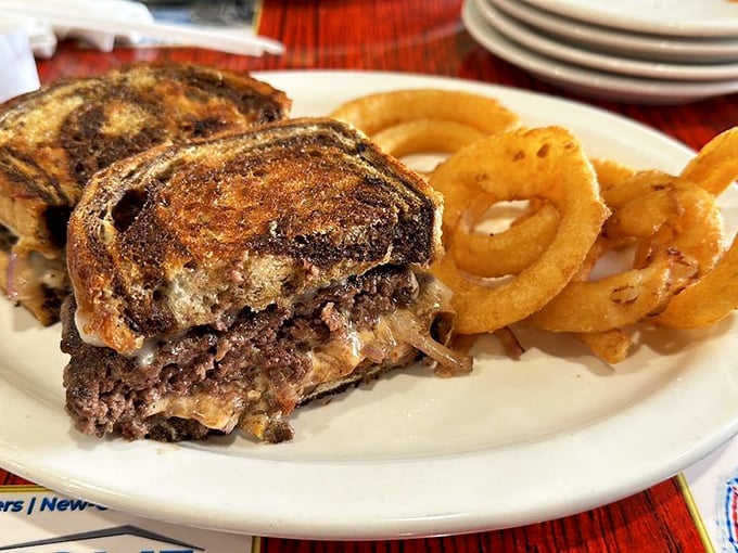 The patty melt meets its crispy onion ring companions – comfort food that doesn't apologize for being absolutely indulgent.
