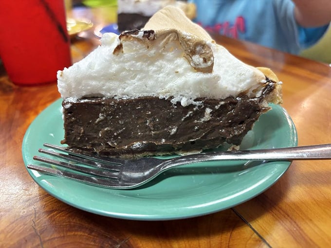 A slice of chocolate cream pie with mile-high meringue that defies both gravity and restraint. Save room for dessert—or start with it!