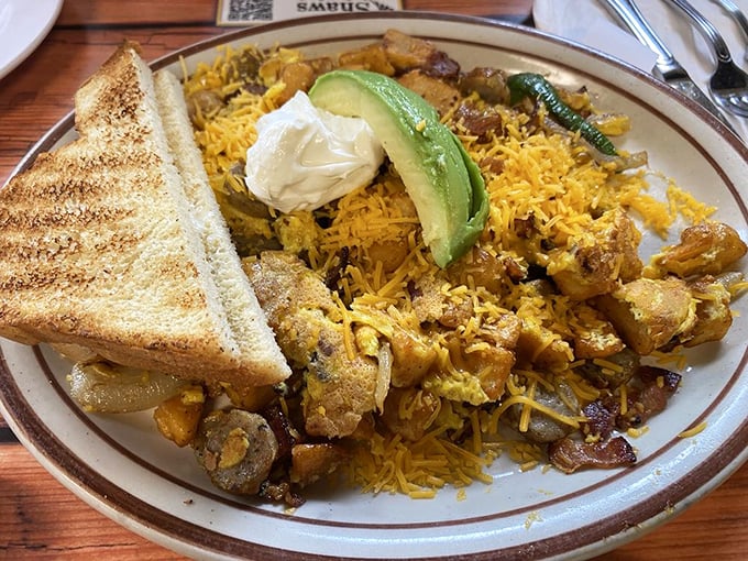 A mountain of breakfast potential. Eggs, potatoes, cheese, and toast—the four food groups of morning happiness.