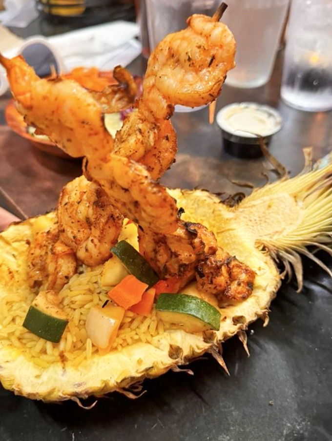 Shrimp skewers rising from pineapple rice like prehistoric spears – proof that presentation isn't just for fancy restaurants without dinosaur themes.