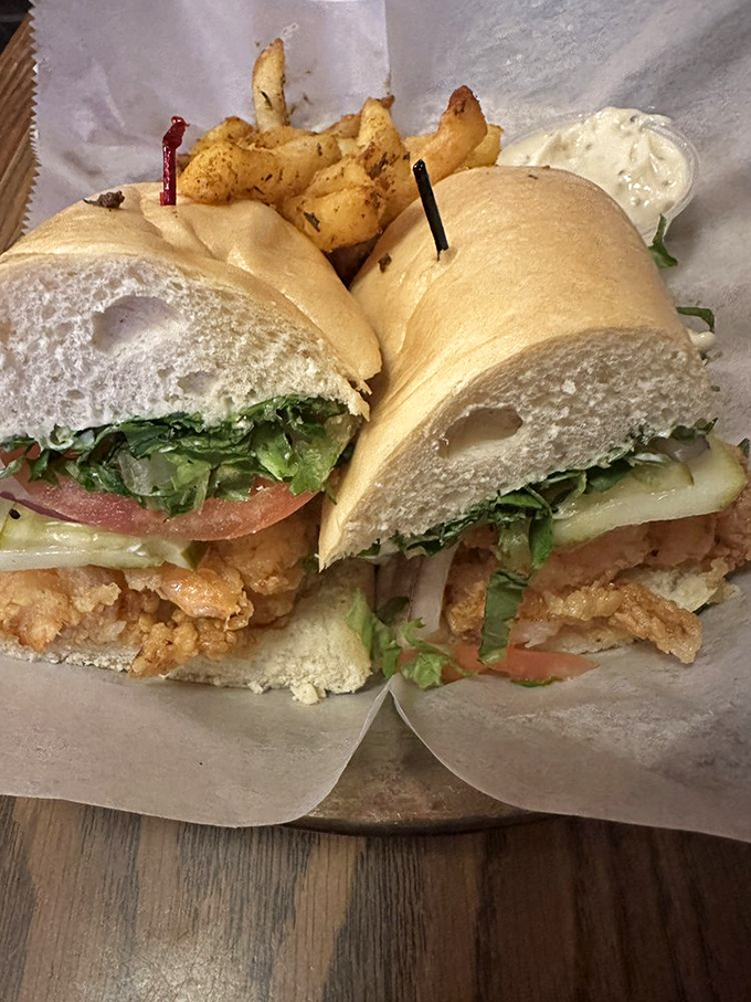 This po' boy is anything but poor – stuffed with crispy seafood and fresh veggies on French bread that crackles with each bite.