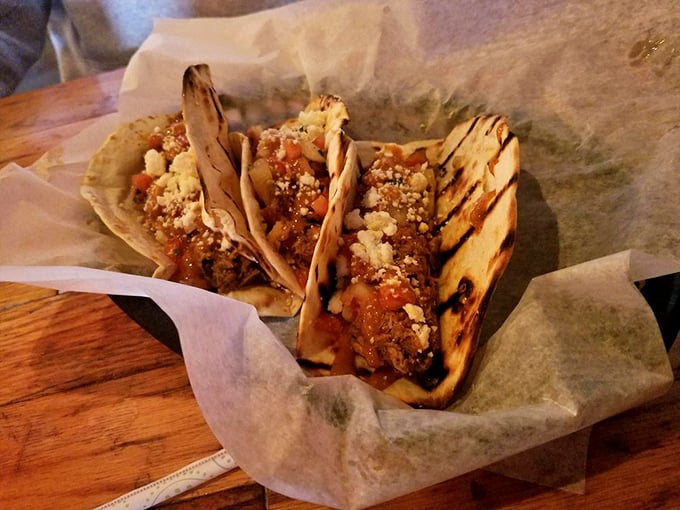 Tacos reimagined through a BBQ lens. Smoky meat nestled in grilled tortillas with a sprinkle of cheese – a cross-cultural masterpiece that works brilliantly.