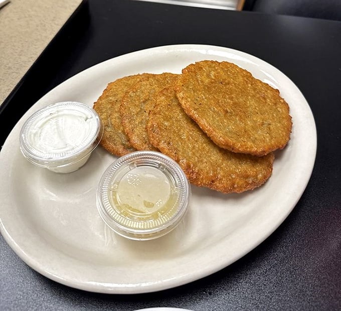 Golden-brown potato pancakes with sides of sour cream and applesauce—the perfect supporting actors to your sandwich superstar.