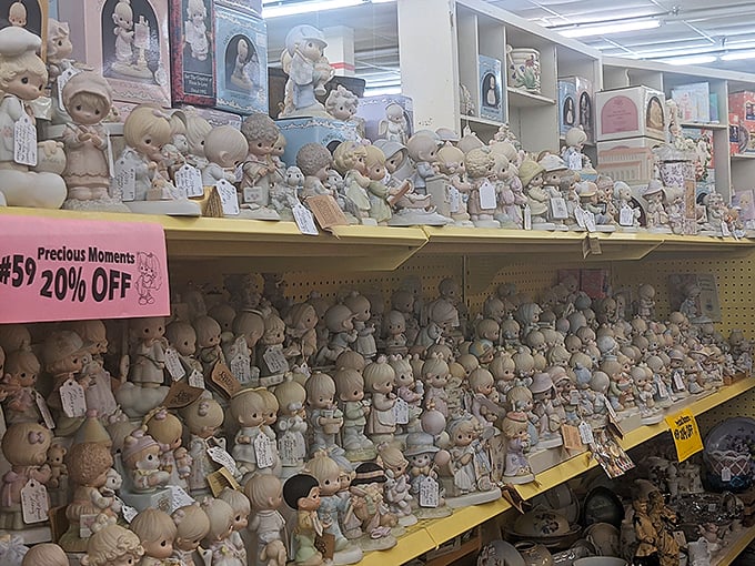 The Precious Moments figurines section: where wide-eyed porcelain children silently judge your life choices from their pastel perches.