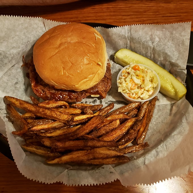A pulled pork sandwich that doesn't need fancy tricks to impress – just honest flavor and perfect execution. Those fries look hand-cut and heaven-sent.