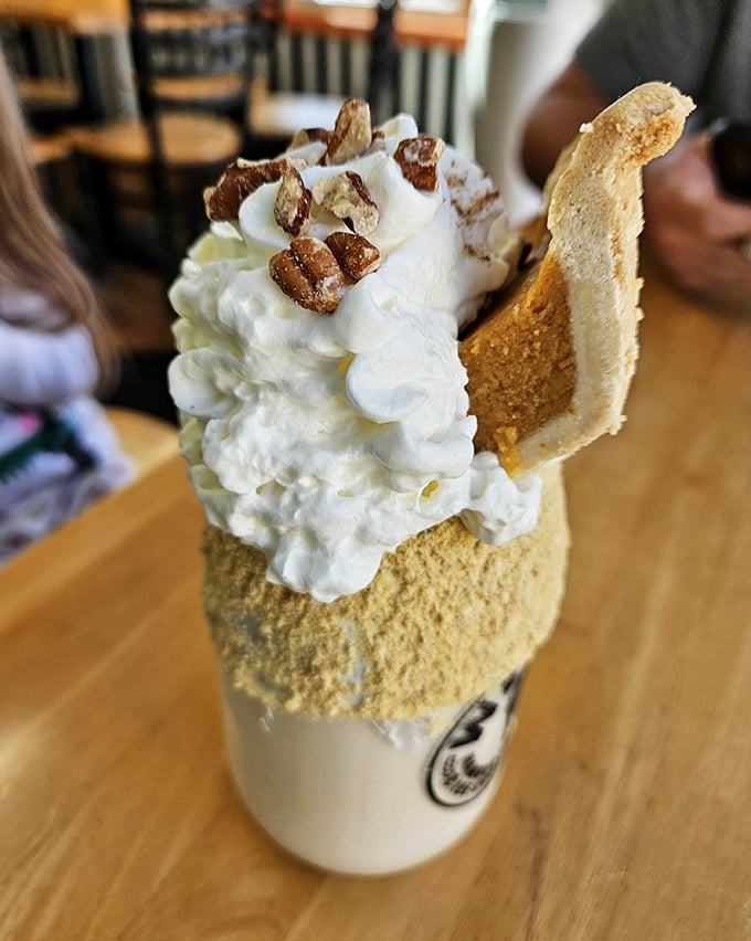 Whipped cream, candied pecans, and what appears to be pumpkin pie in drinkable form—autumn's greatest hits album in a glass.